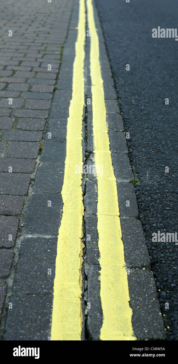 double yellow line dissapering into the distance Stock Photo - Alamy