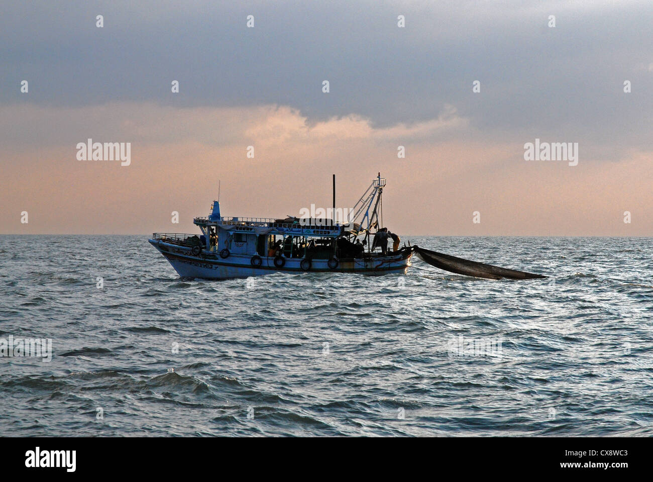 Egyptian fishing boat hauling in a mid water trawl used for catching ...