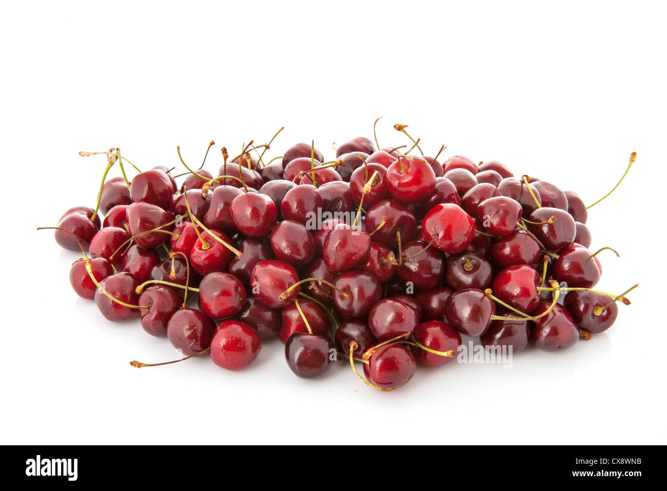 Many fresh red cherries isolated over white background Stock Photo - Alamy