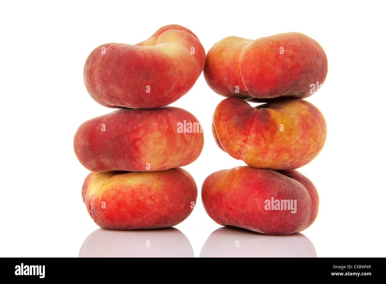 Stacked wild peaches isolated over white background Stock Photo - Alamy