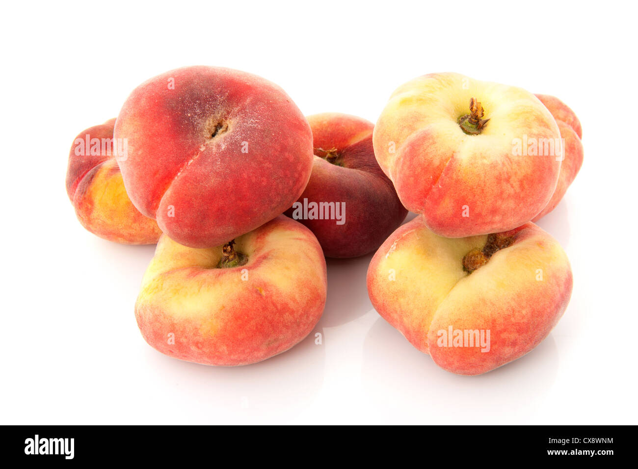 Pile wild peaches on white background Stock Photo - Alamy
