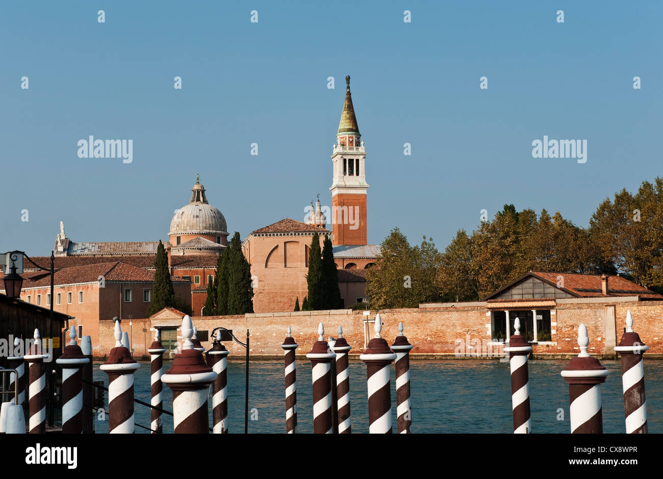 Traditional striped mooring posts outside the Hotel Cipriani in Venice ...