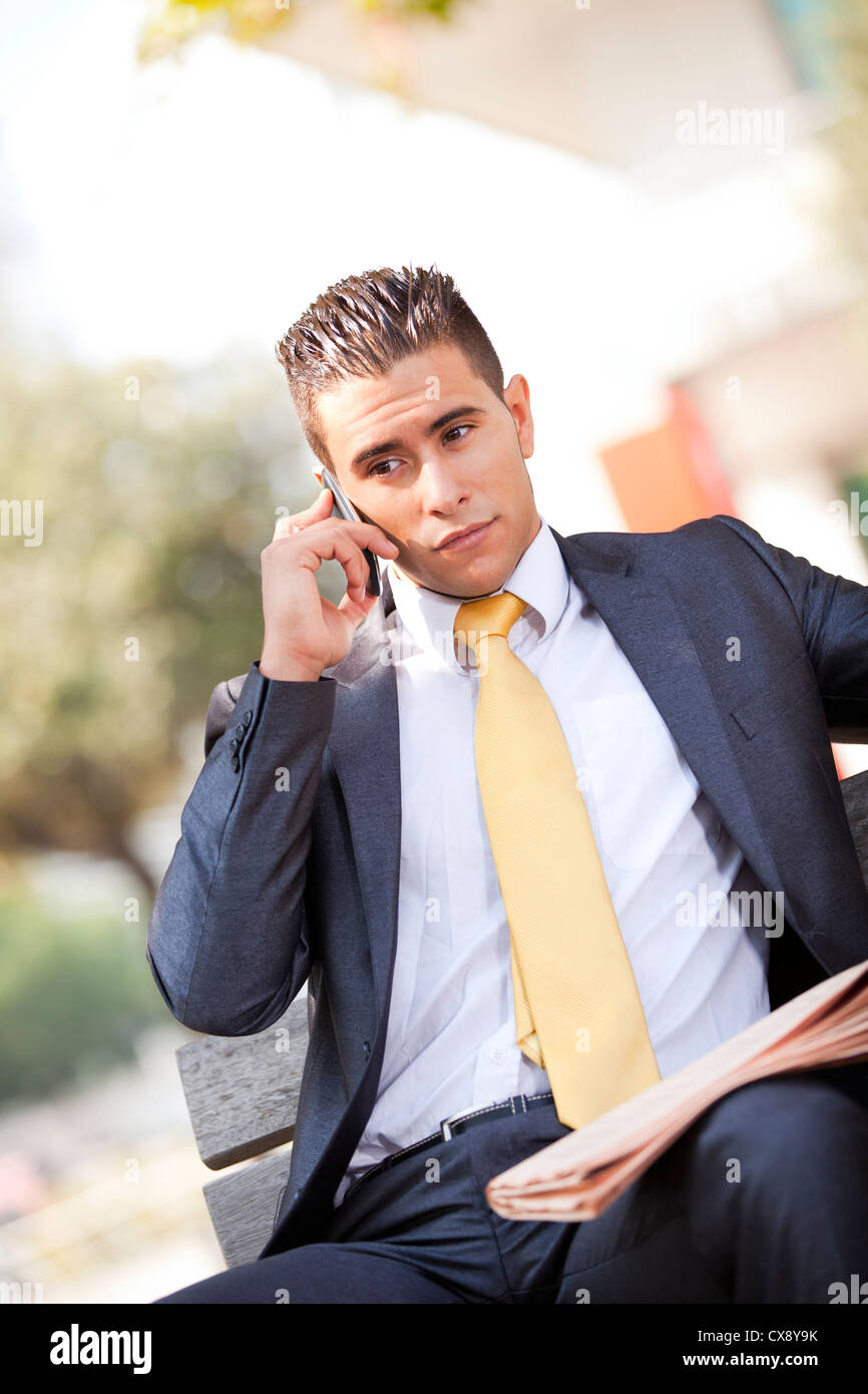 Businessman on bench newspaper hi-res stock photography and images - Alamy
