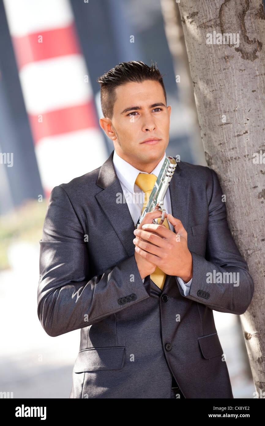 Powerful security businessman aiming a gun Stock Photo - Alamy