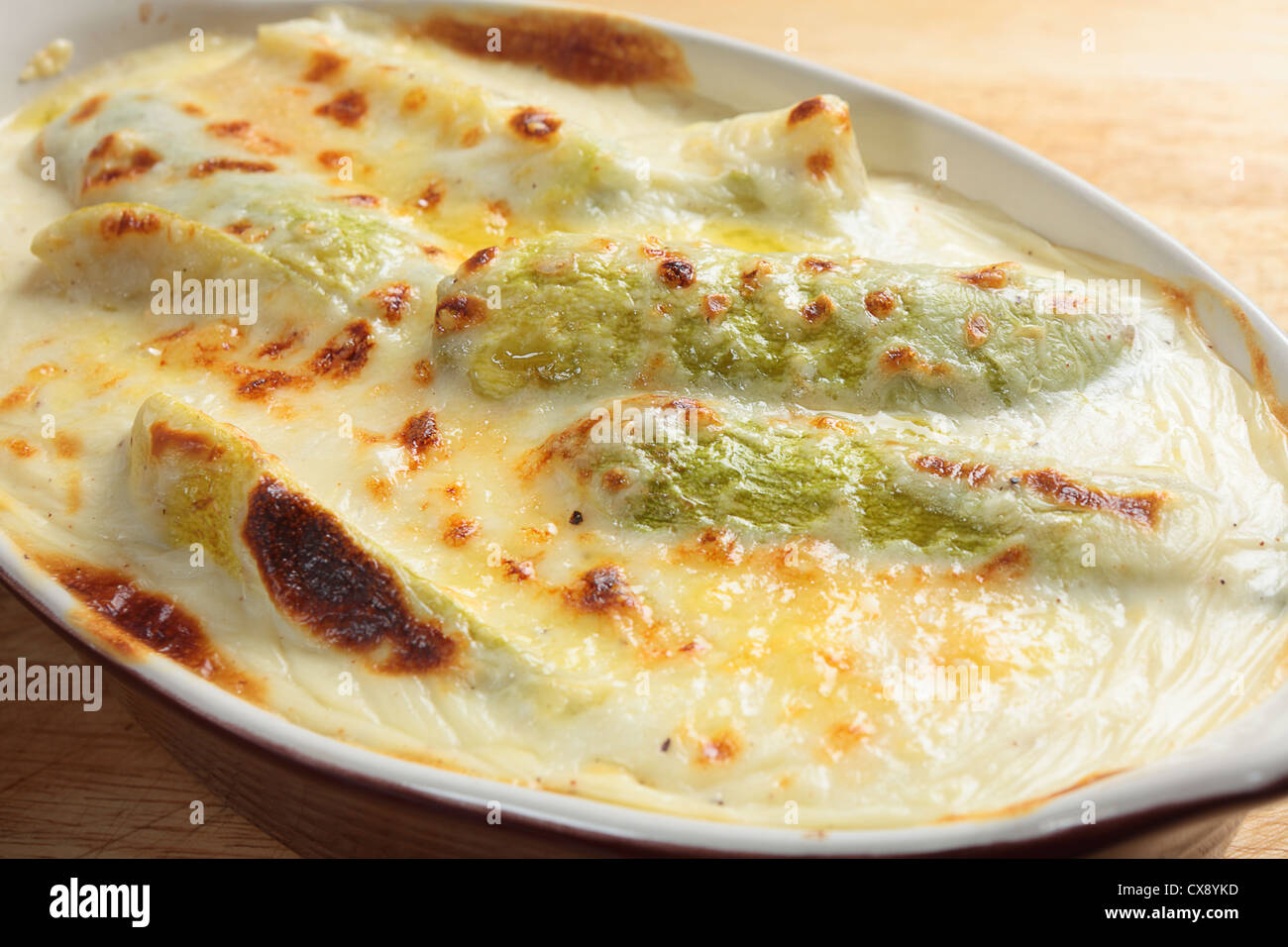 Courgettes baked in a garlic flavoured bechamel sauce topped with ...