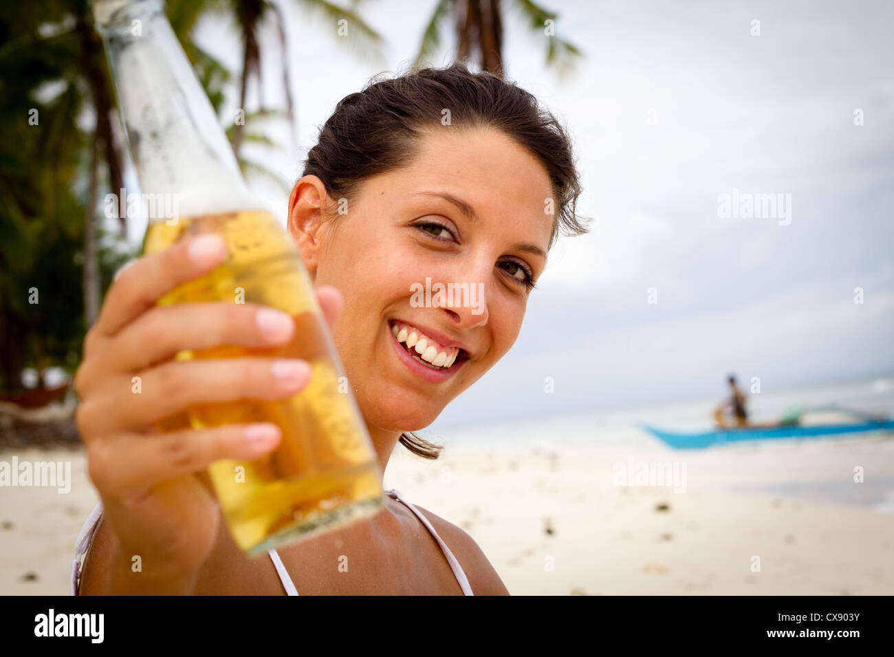 young woman with beer on beach Stock Photo - Alamy
