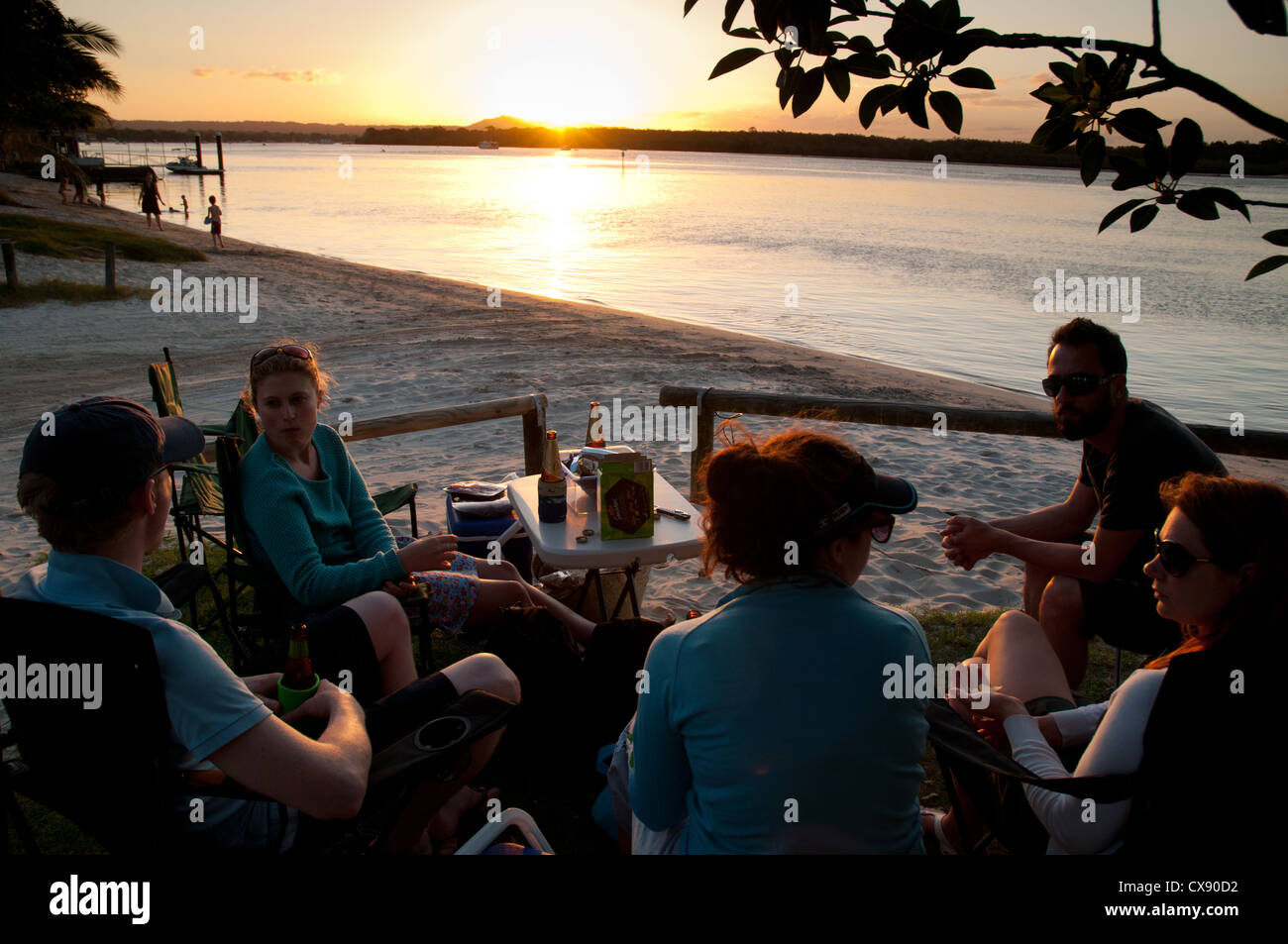 Friends at sunset Stock Photo - Alamy