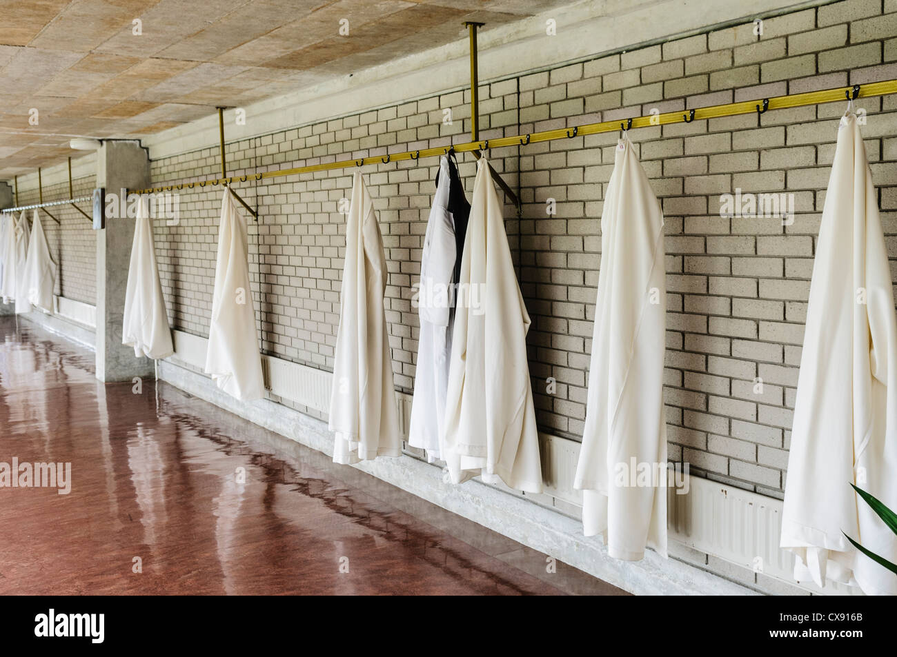 Monastic robes for monks in a monastery hanging on a wall Stock Photo ...
