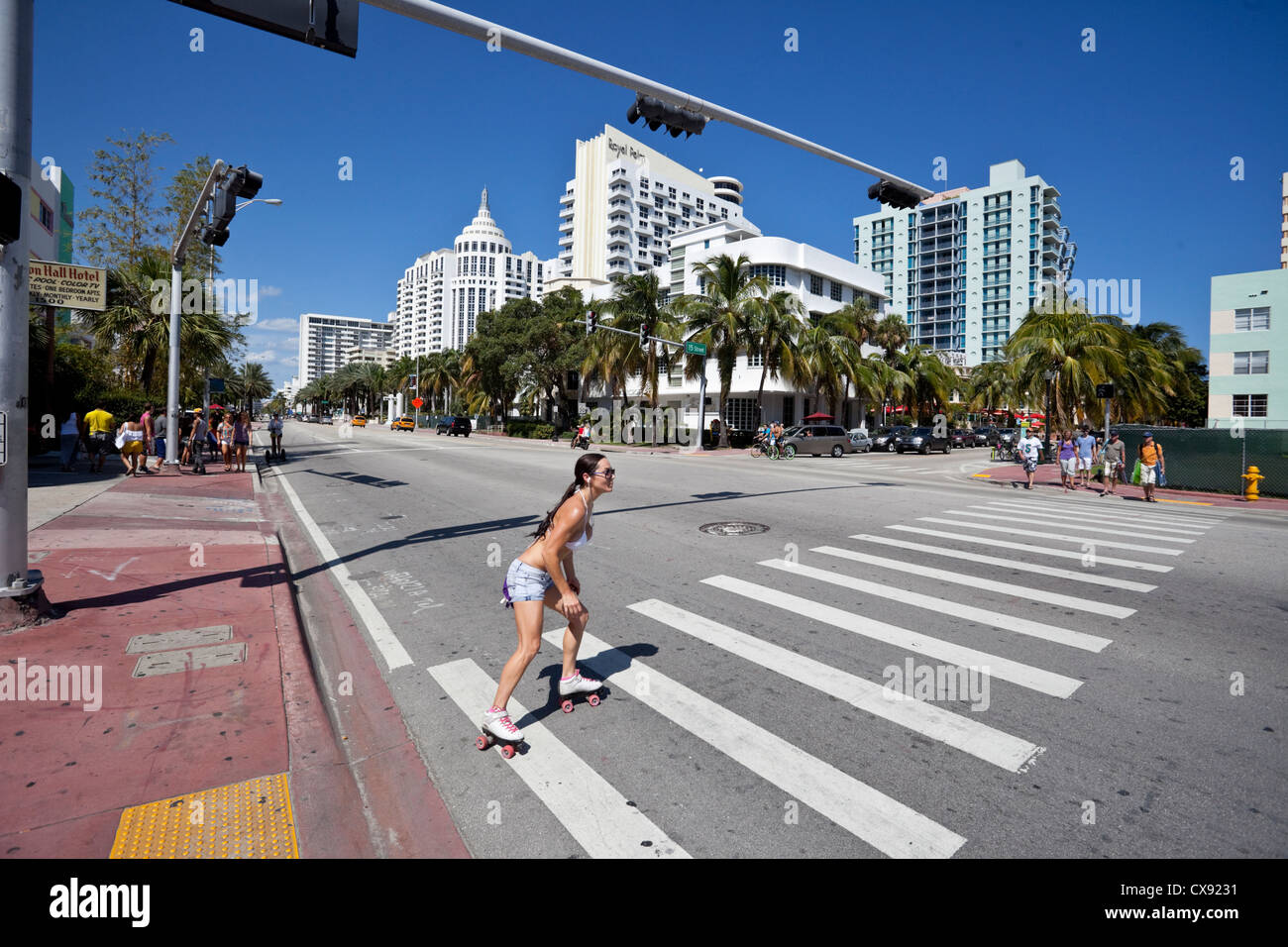 Roller skater crossing the street on Collins Avenue, South Beach, Miami ...