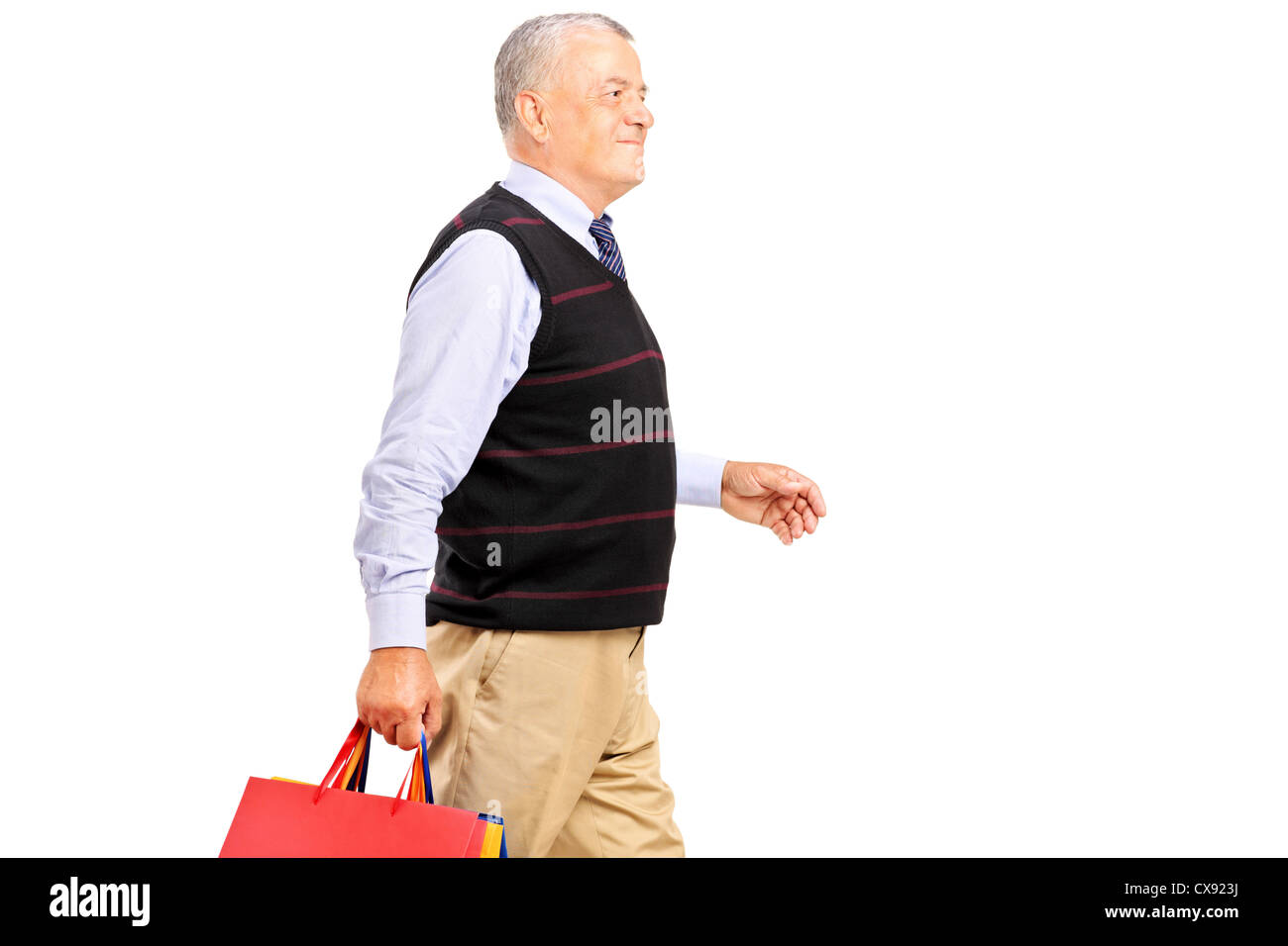 A mature man coming back after shopping isolated on white background ...
