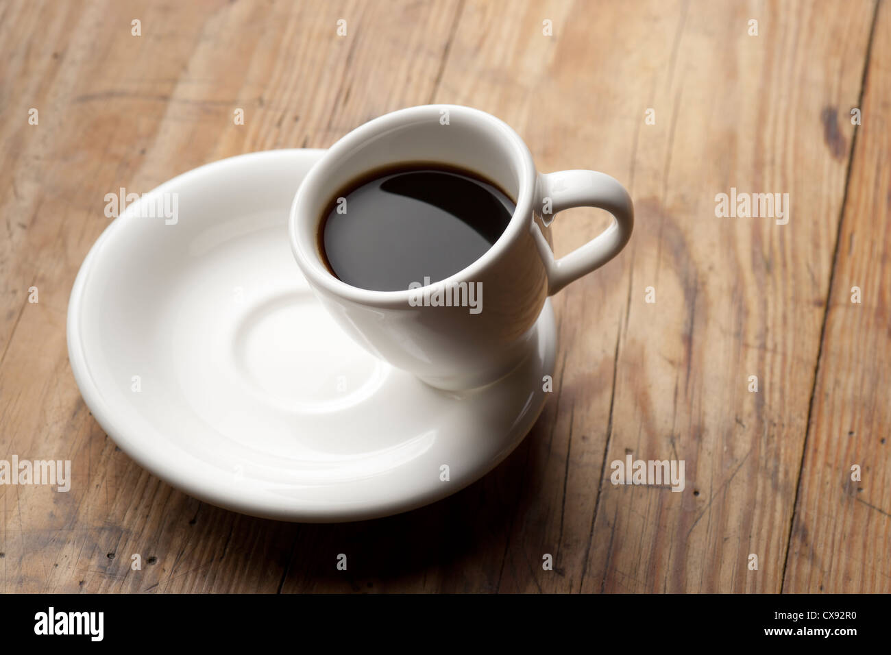 Coffee in tilted white porcelain coffee cup Stock Photo - Alamy