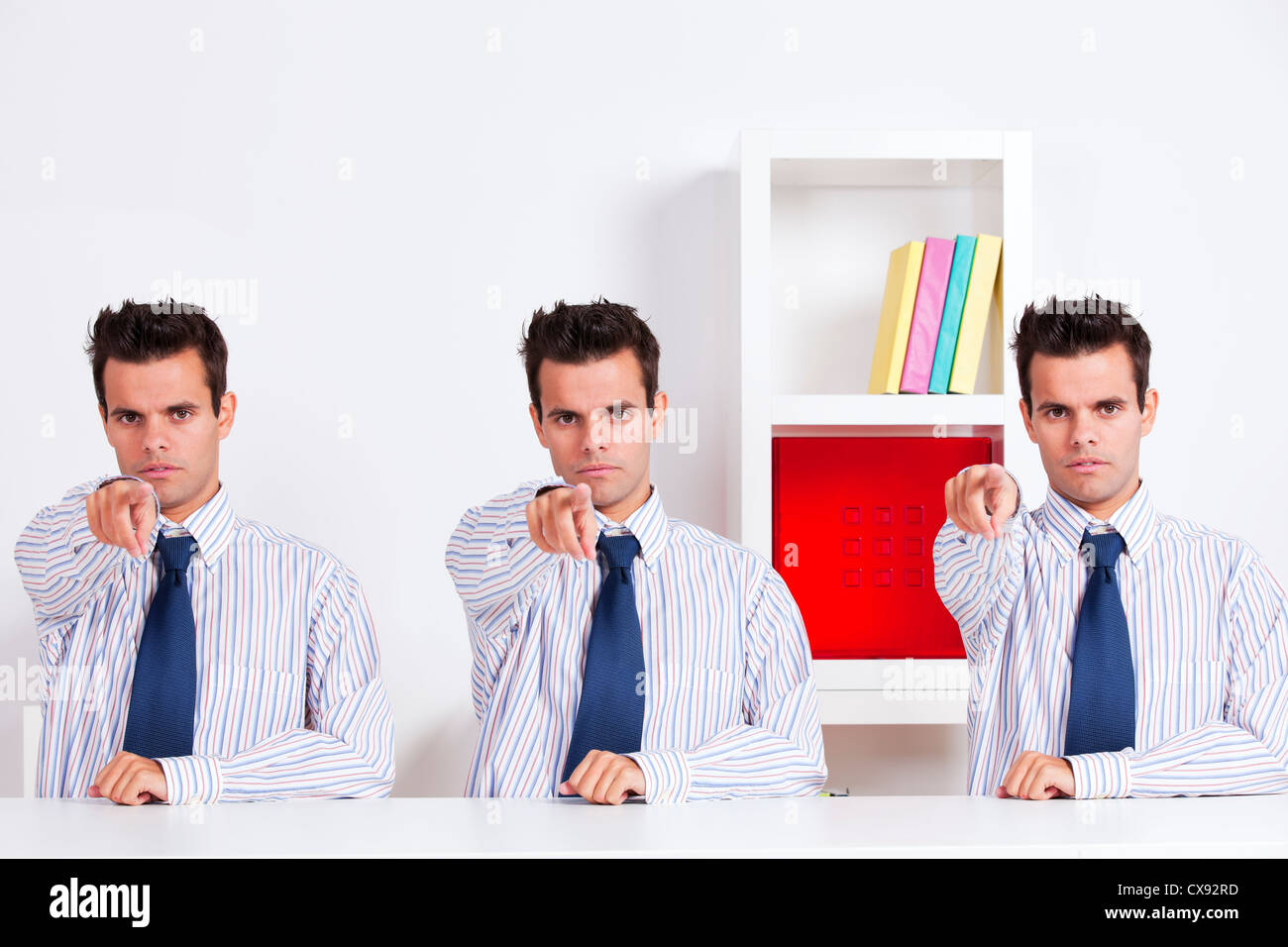 Three businessman behind the office desk pointing to you Stock Photo ...