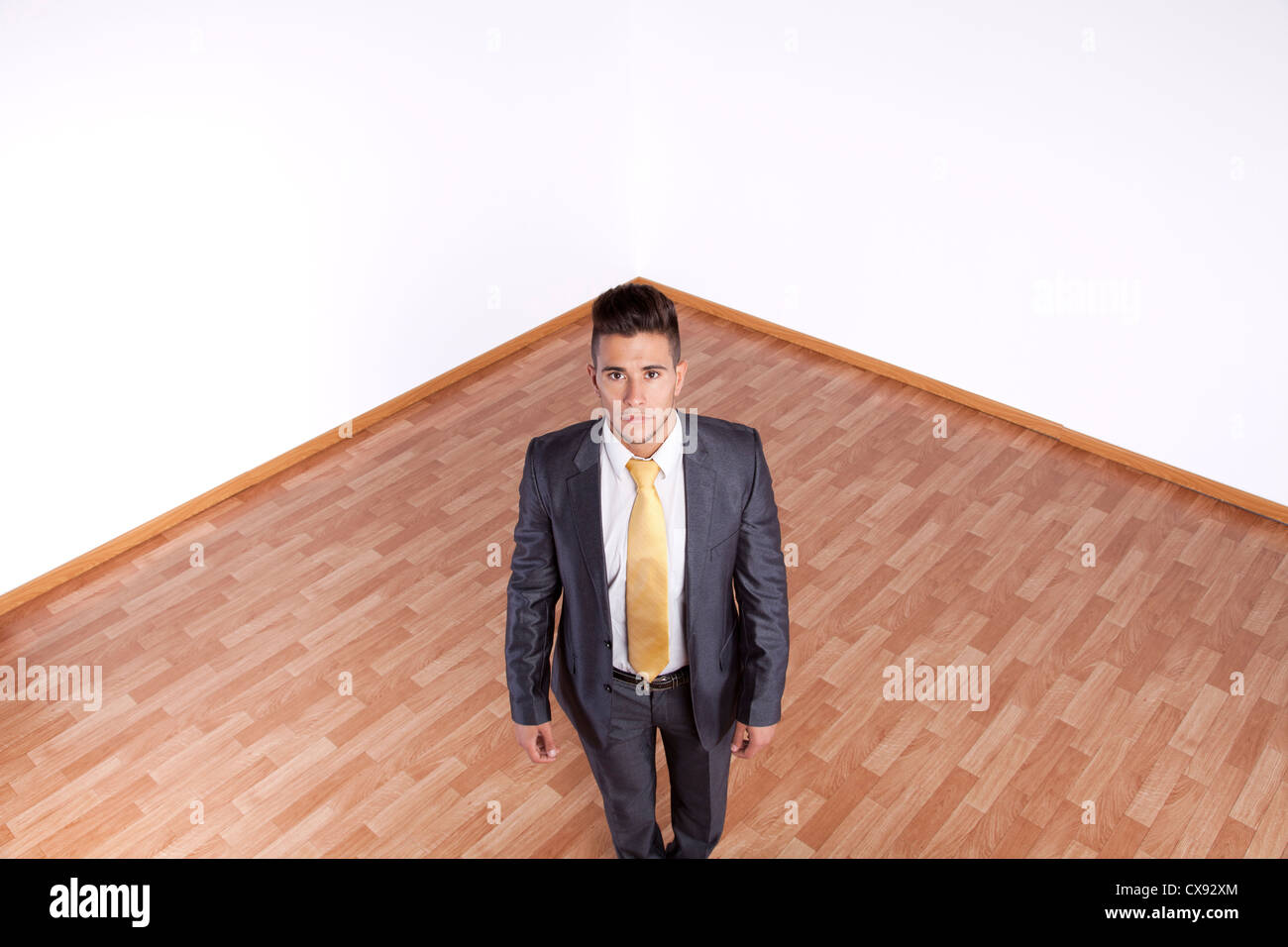 High view of a businessman looking up in an empty room Stock Photo - Alamy