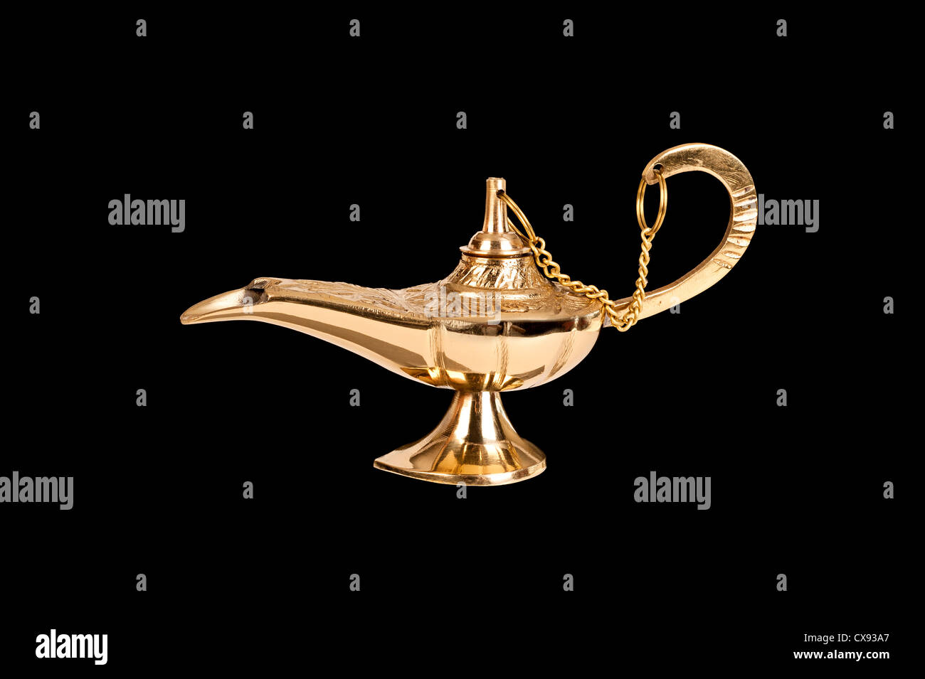 An antique brass oil lamp of genie fame truly isolated on black Stock ...