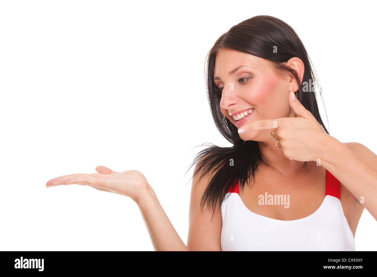 Young woman showing product with open hand palm - excited expression on ...