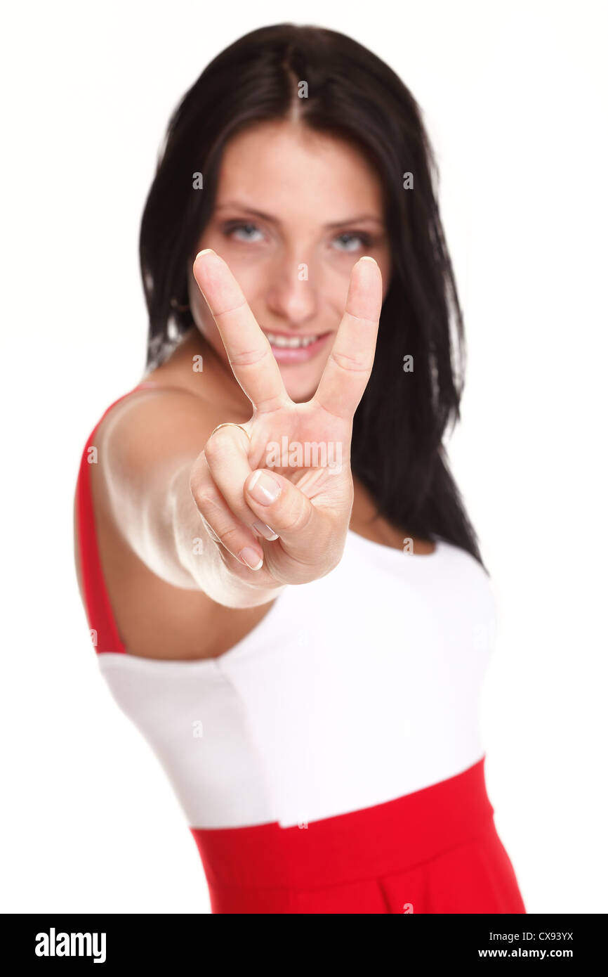 Portrait of a pretty young woman showing the peace sign Stock Photo - Alamy