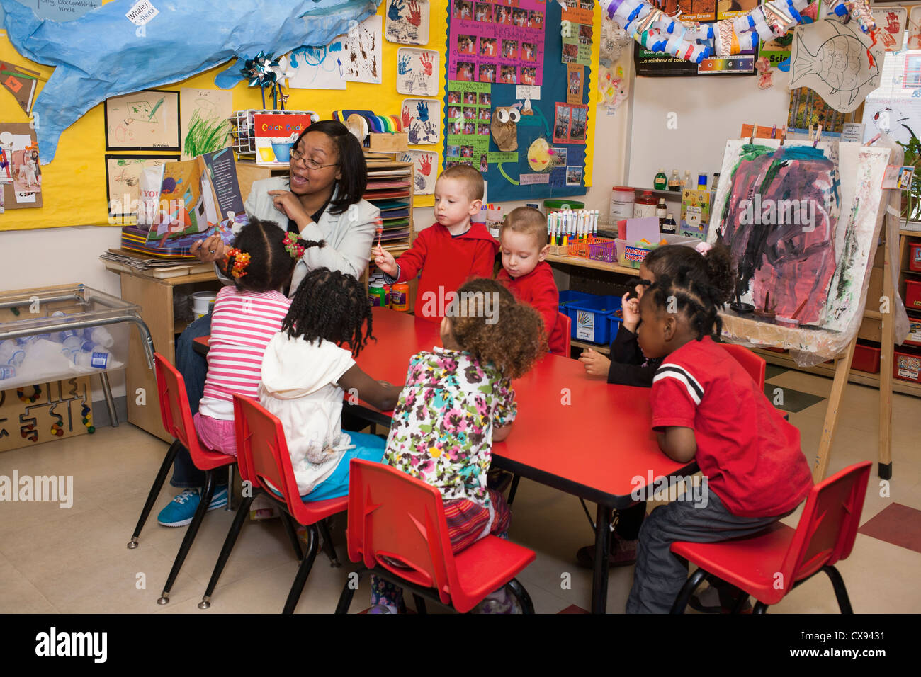 Female African-American preschool teacher reading to her class Stock ...
