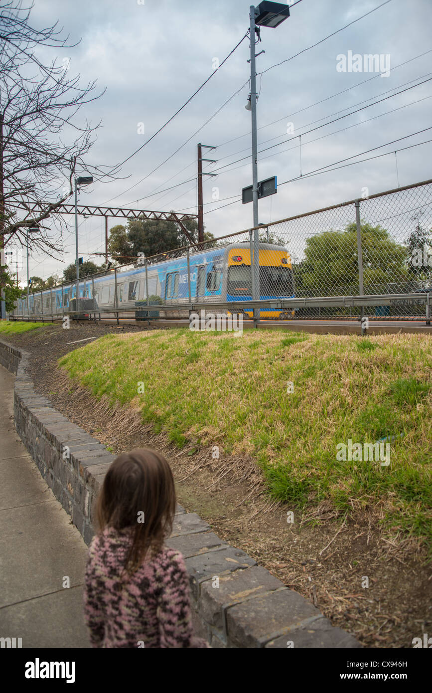 Child watching a train go past in Melbourne city Stock Photo - Alamy