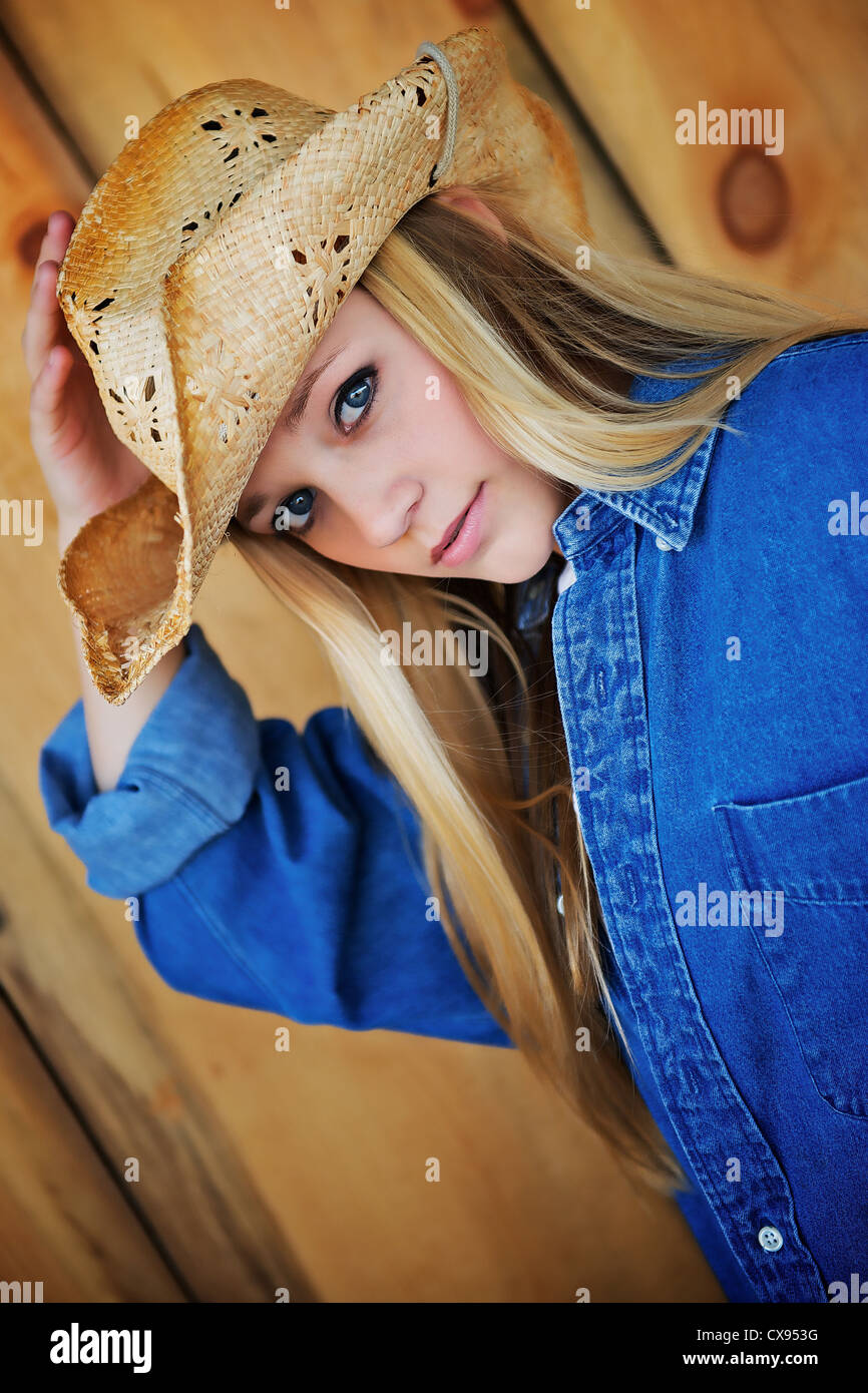 Attractive Blond Model Peers Out From Under Her Tattered Cowboy Hat ...