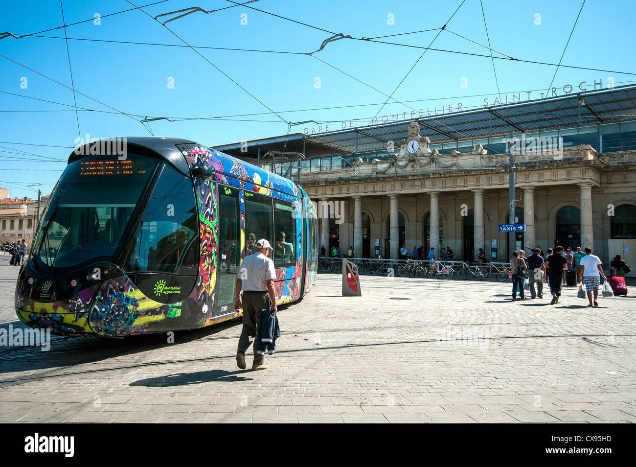 Modern TaM tram passing by Saint-Roch Railway Station in Montpellier ...