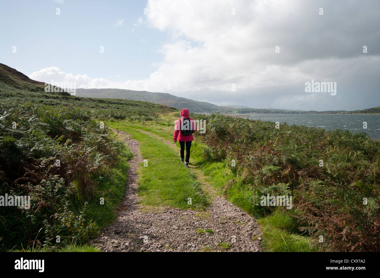 Rear View Of A Woman Person Walking Through The Countryside Wearing ...