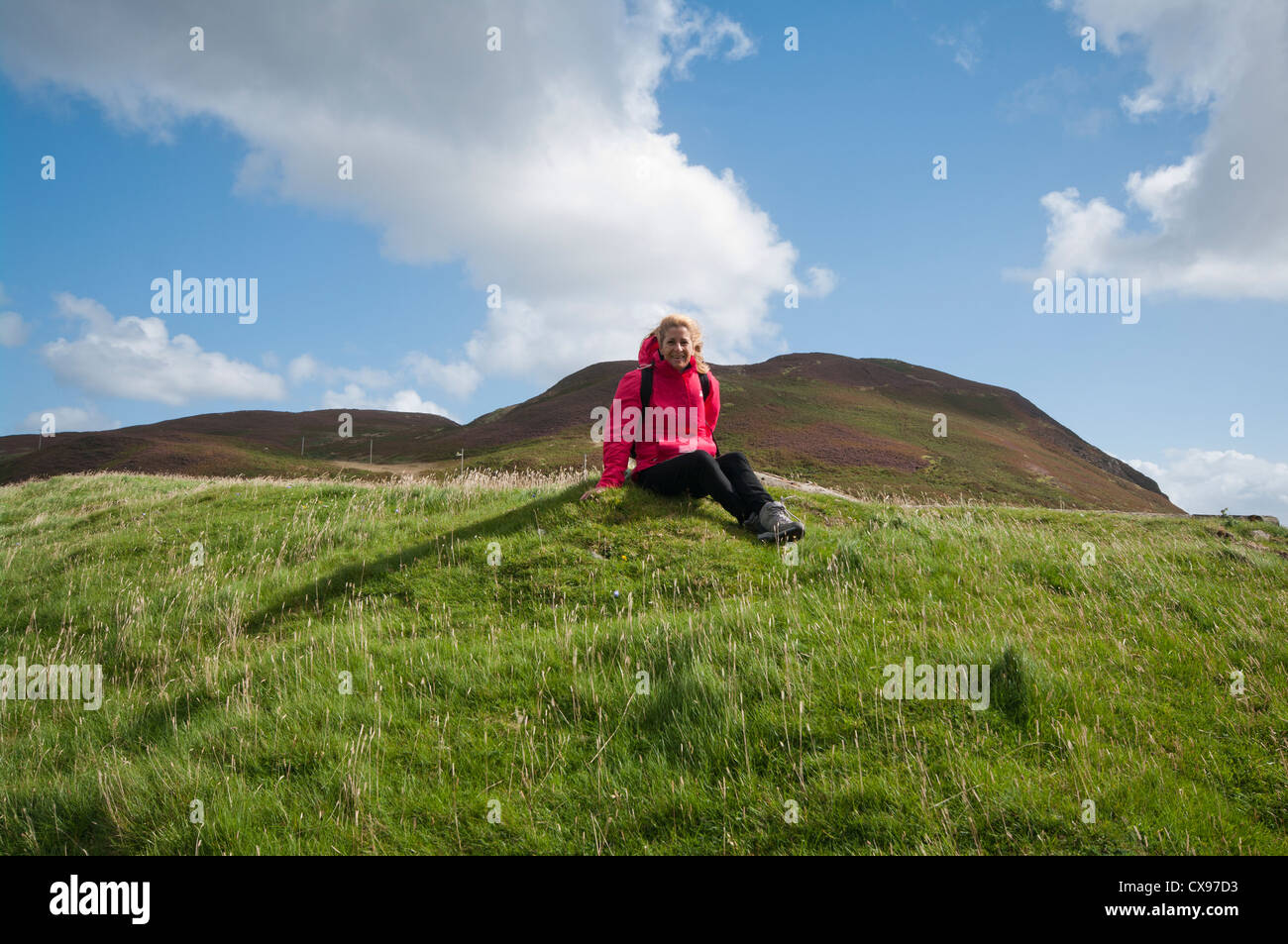 Front View Of A Woman Rambler Walker Person Sitting On The Grass In The ...