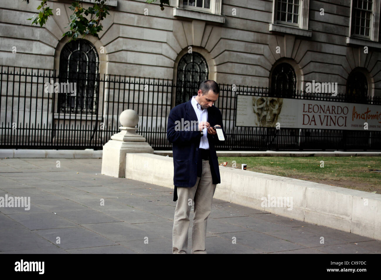 Man using his mobile phone on a London street Stock Photo - Alamy