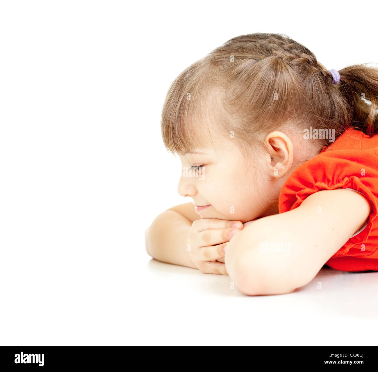 Girl lying on floor looking ahead isolated on white with empty space ...