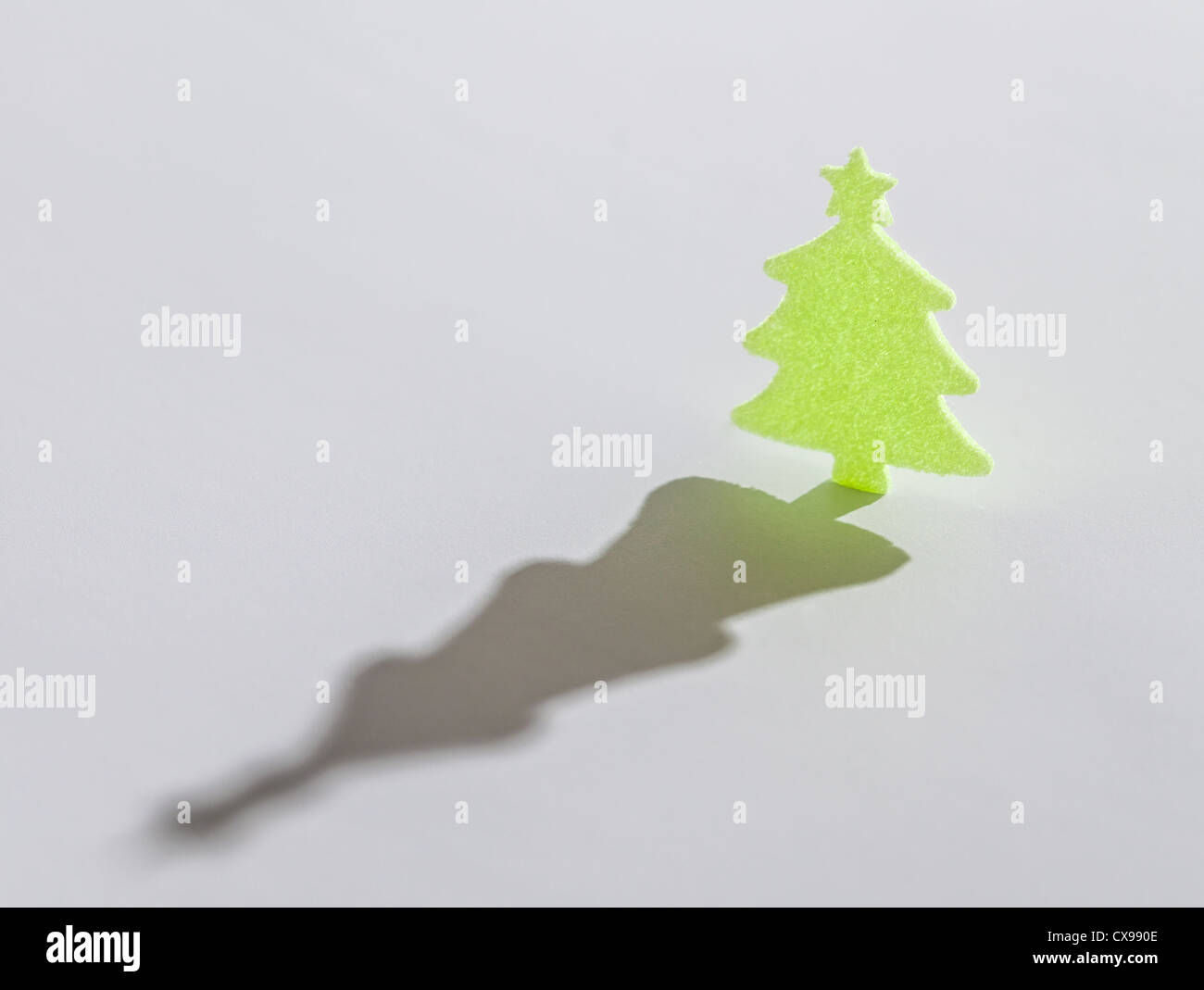 small green christmas tree with long shadow on white background Stock ...