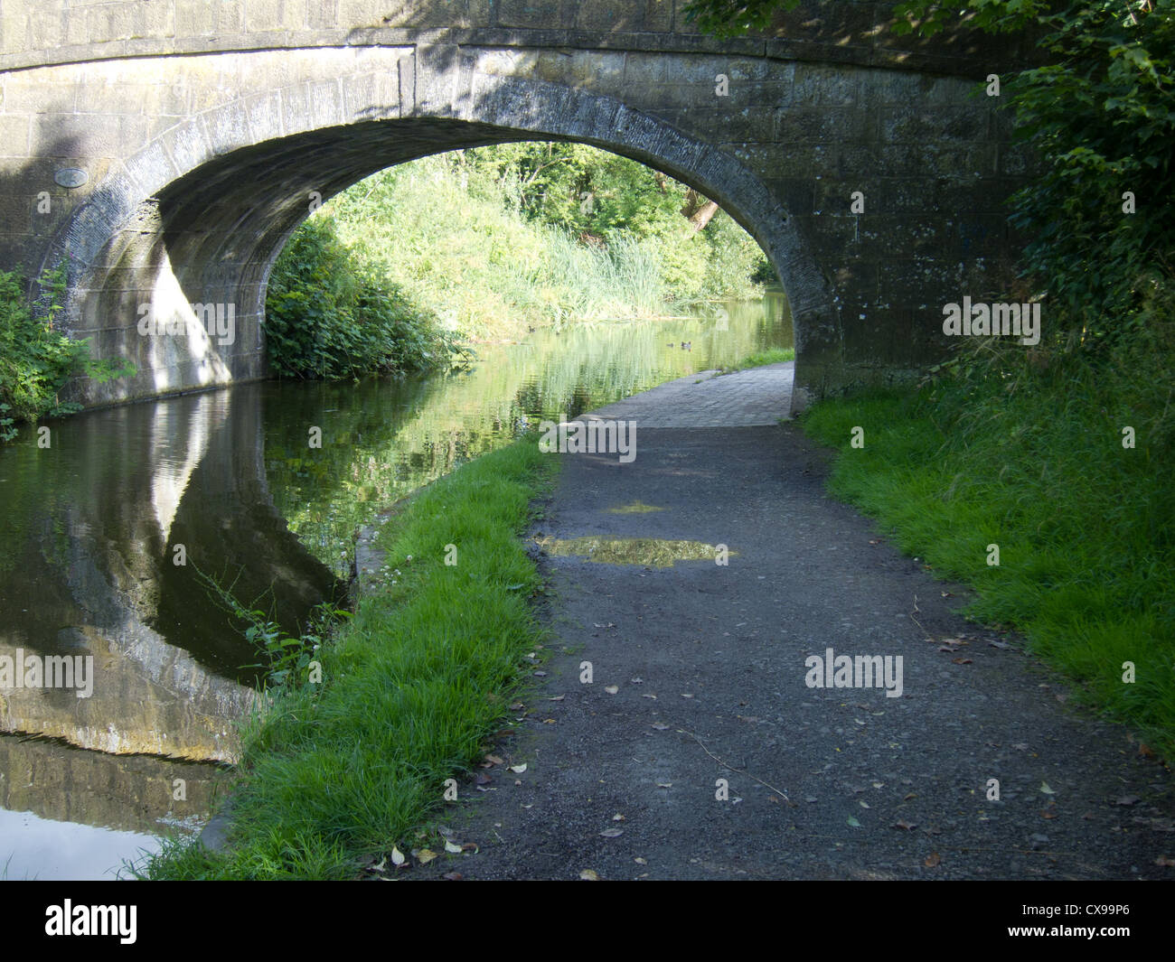 circular reflection of a traditional stone bridge over the still calm ...
