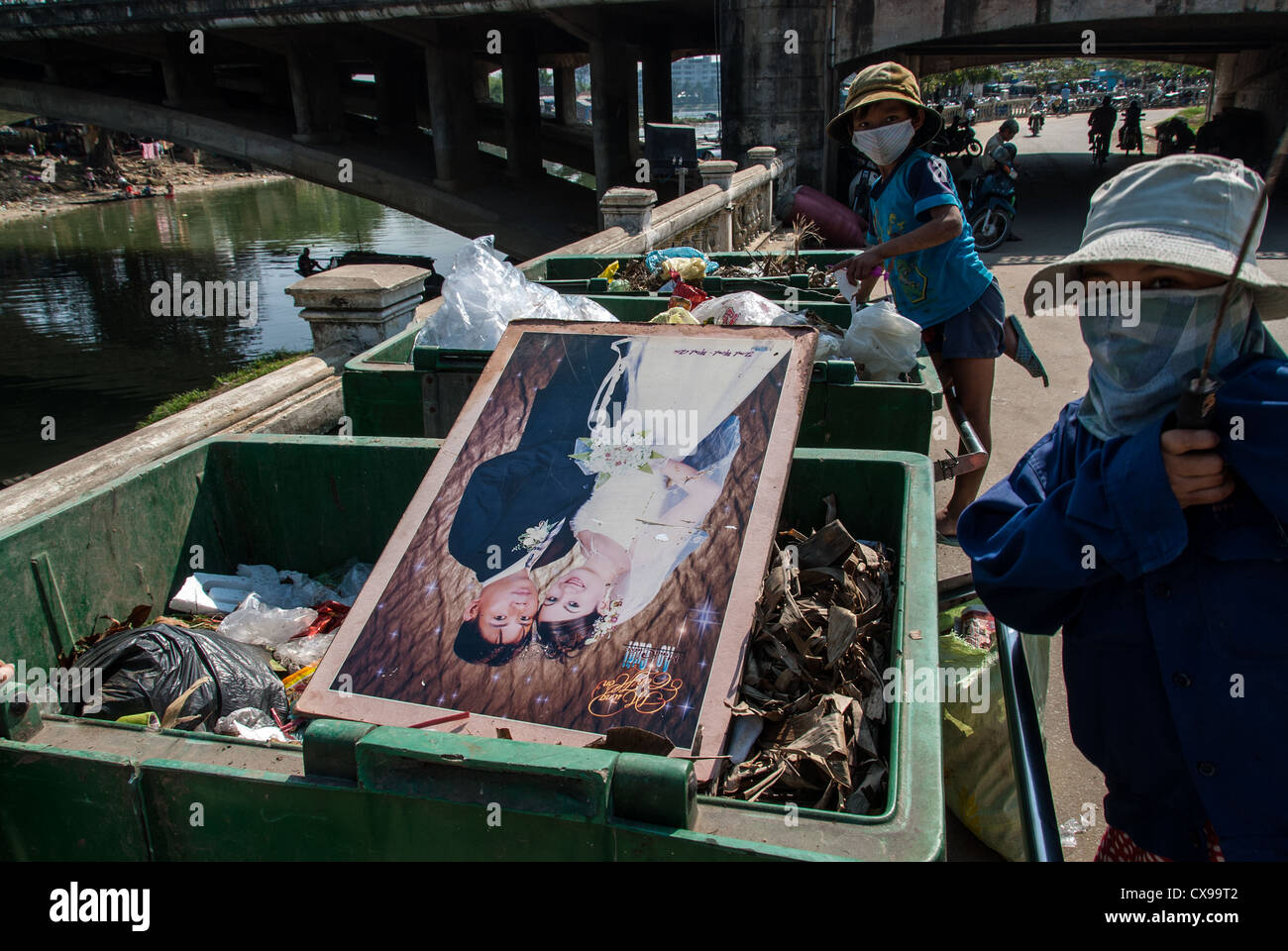Two poor boys try to find food or clothes in garbage cans on January 12 ...