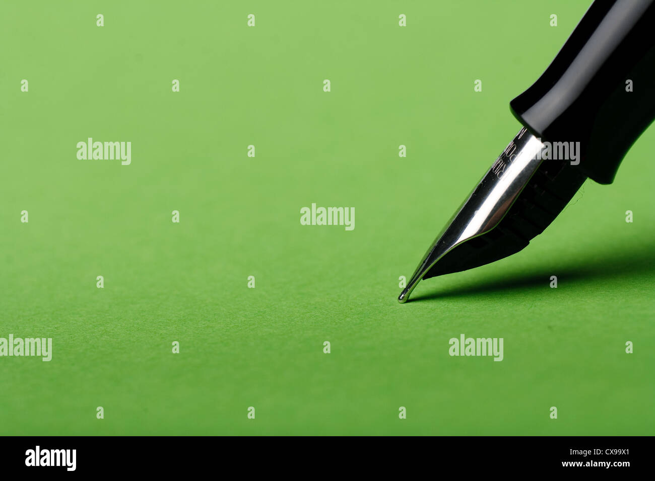 Fountain pen on green background Stock Photo - Alamy