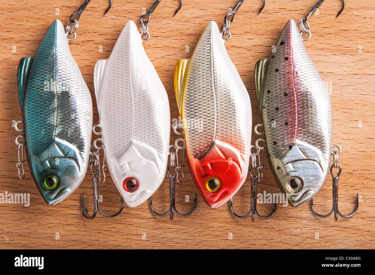 bait for fishing - different wobbler on light wood Stock Photo - Alamy
