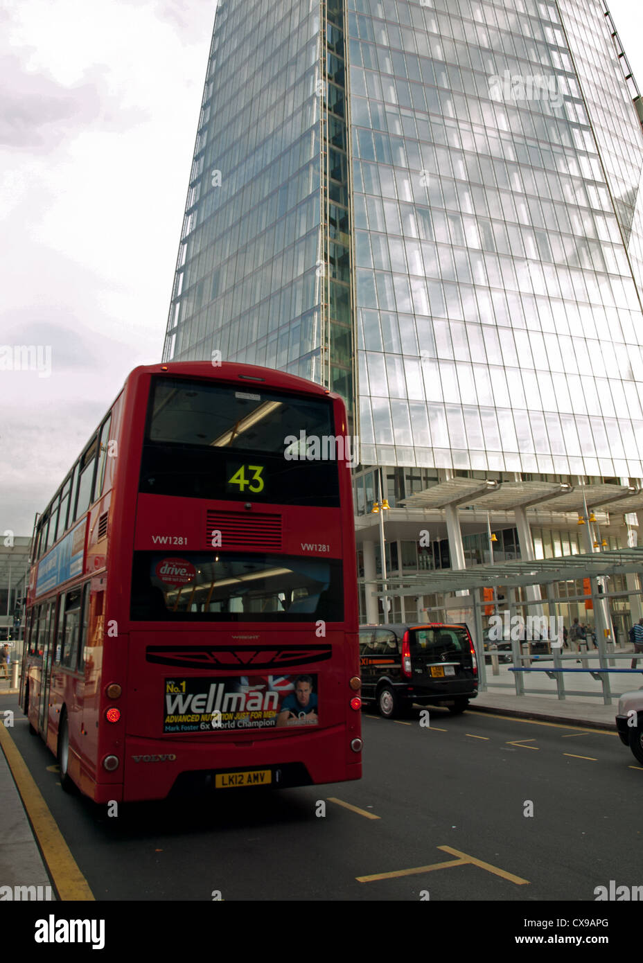 London bus and taxi at London Bridge Station with view of The Shard ...