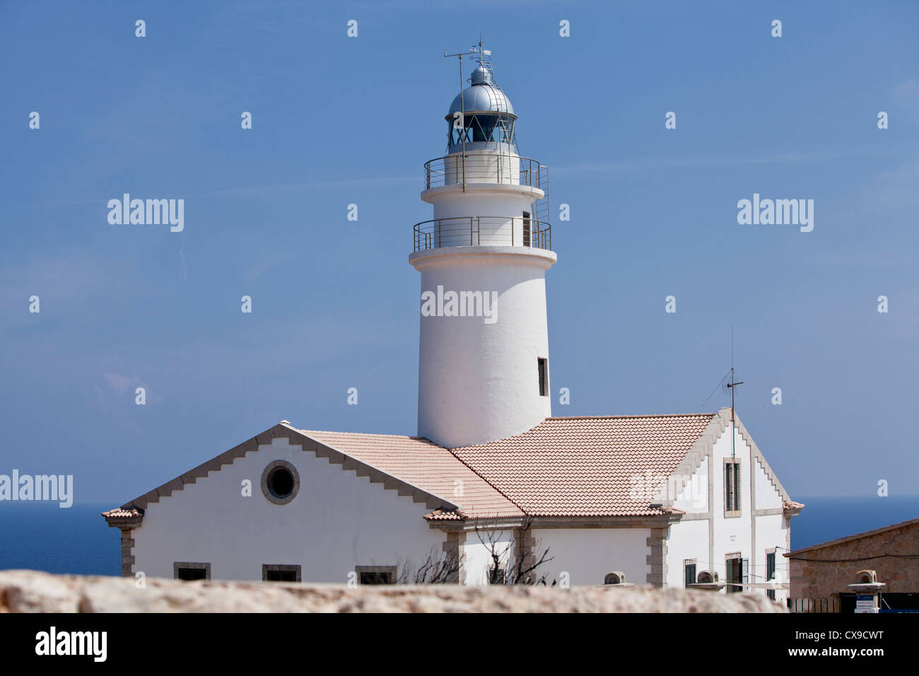 white lighthouse on rocks in the sea ocean water sky blue summer Stock ...