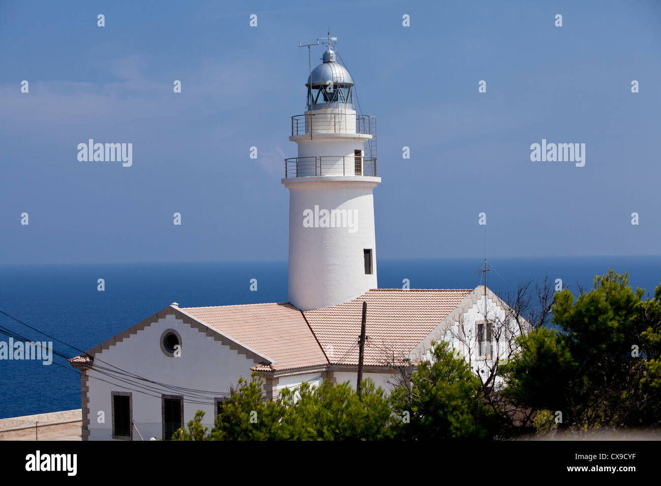 white lighthouse on rocks in the sea ocean water sky blue summer Stock ...
