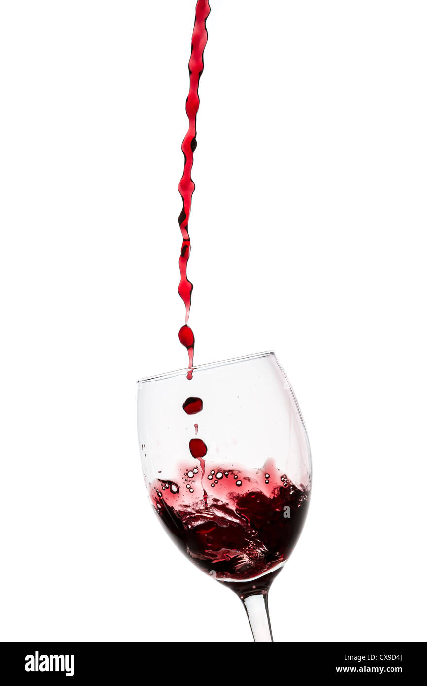 Spilling red wine in the glass on white background Stock Photo - Alamy