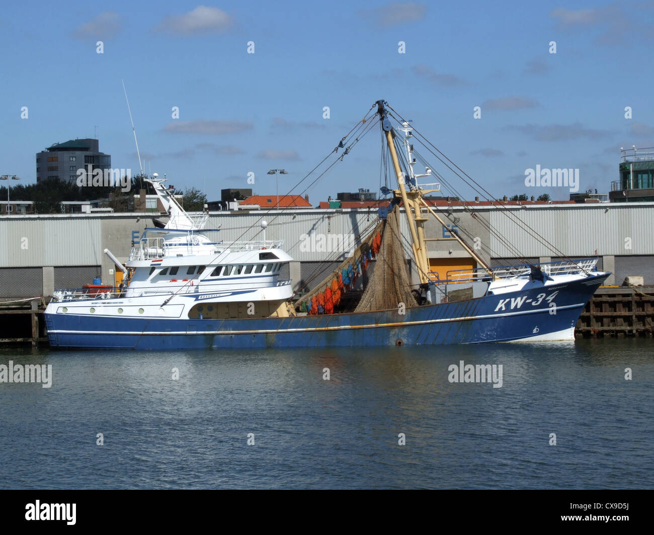 A fishing boat docked at a port, part of the global logistics network ...