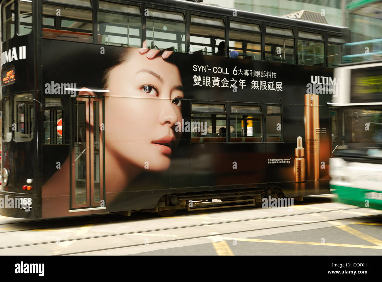 Advertising on Hong Kong double decker trolley buses Stock Photo - Alamy