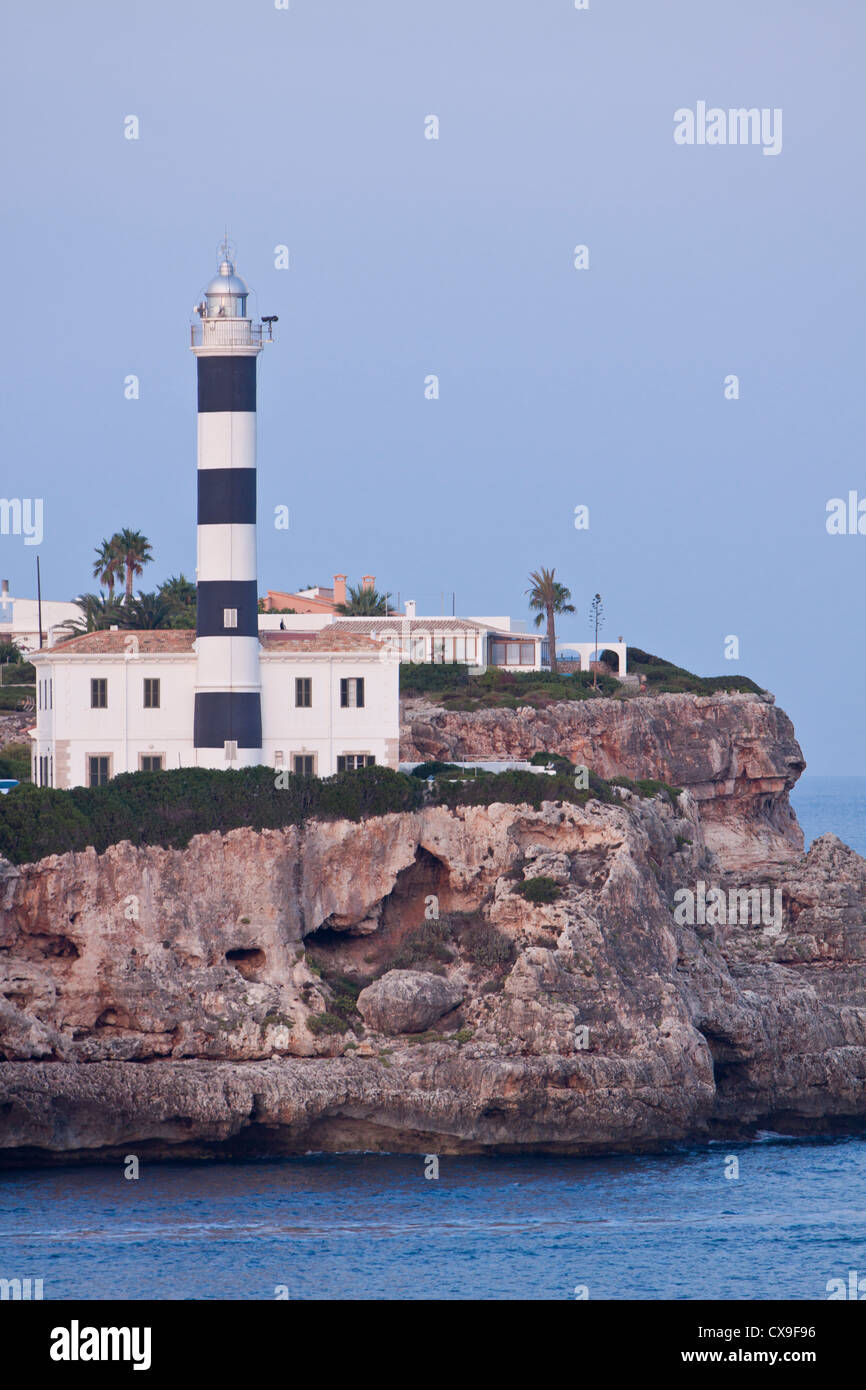 white lighthouse on rocks in the sea ocean water sky blue summer Stock ...