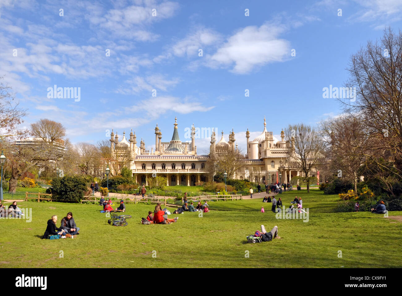 Tourists on the grass enjoying a Spring day in front of historic ...