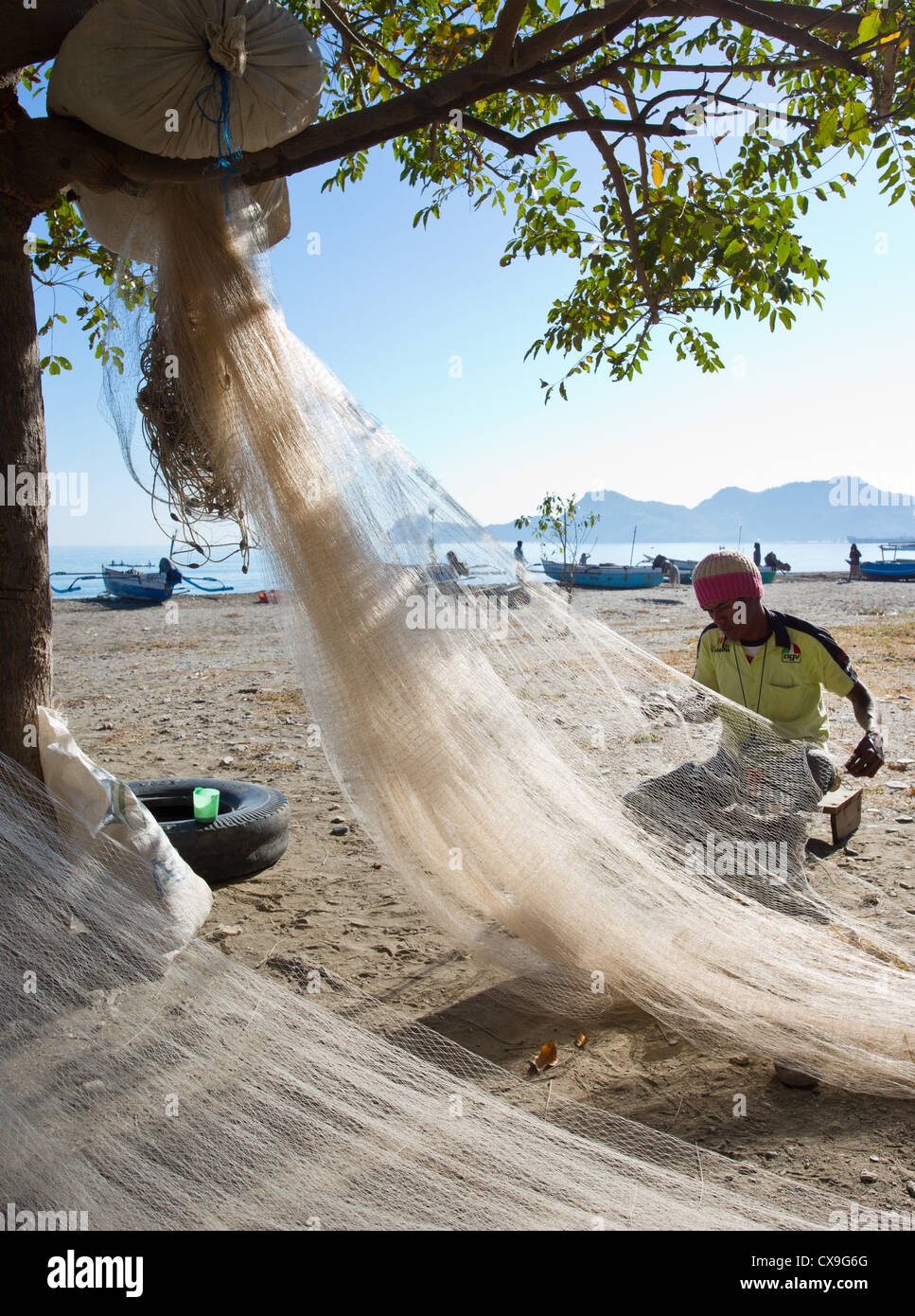 Fishermen mending nets on beach hi-res stock photography and images - Alamy