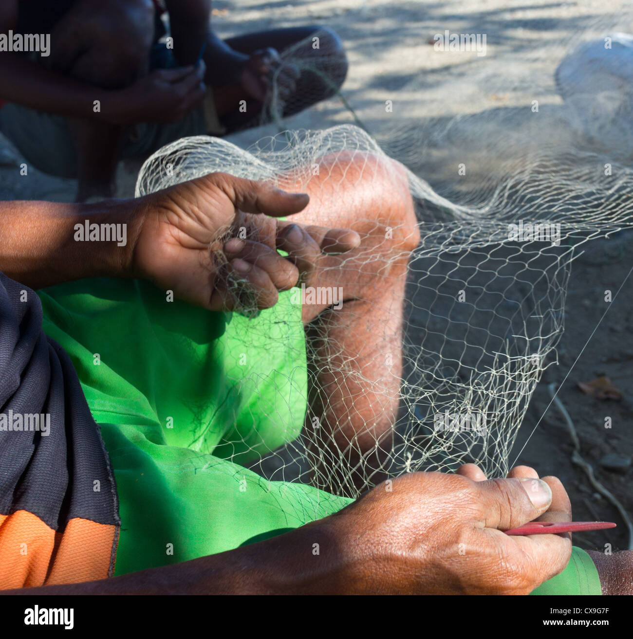 Net fishing mending hi-res stock photography and images - Alamy