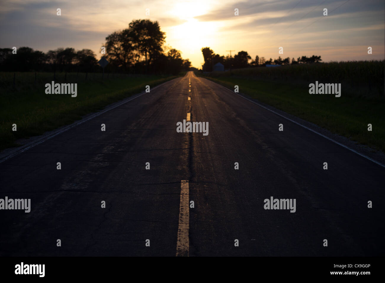 A long highway stretches in to the sunset in rural Illinois Stock Photo ...