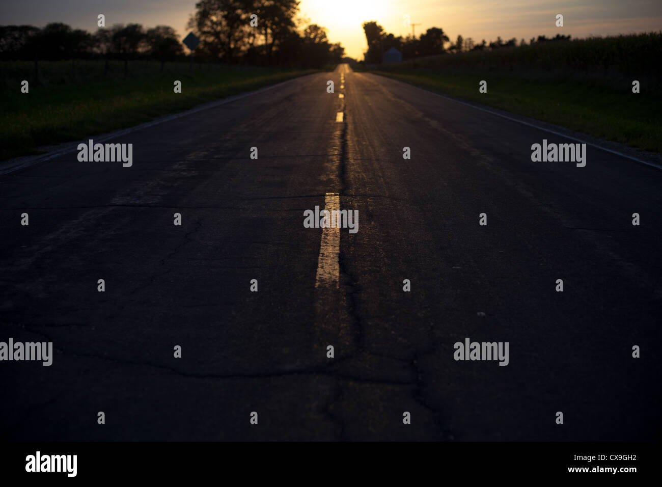 A long highway stretches in to the sunset in rural Illinois Stock Photo ...