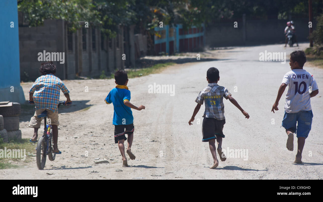 Boys running and playing in the street, Dili, East Timor Stock Photo ...