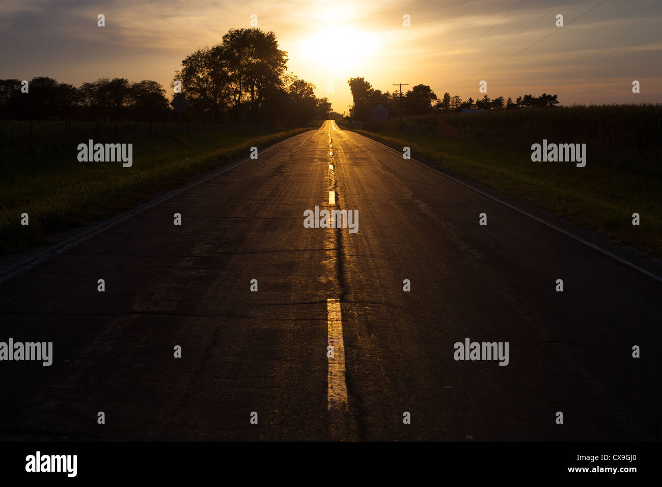 A long highway stretches in to the sunset in rural Illinois Stock Photo ...