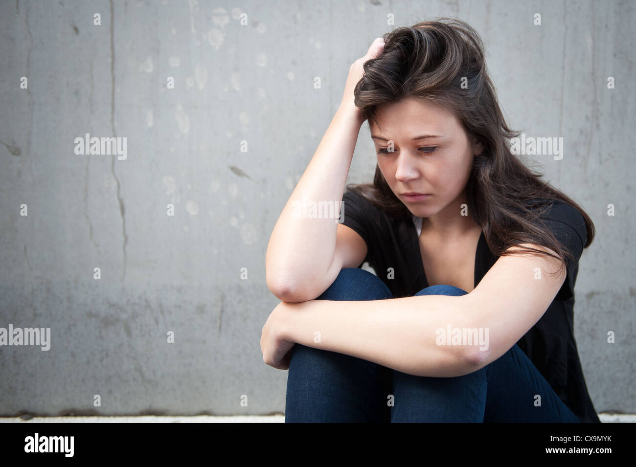 Outdoor portrait of a sad teenage girl looking thoughtful about ...