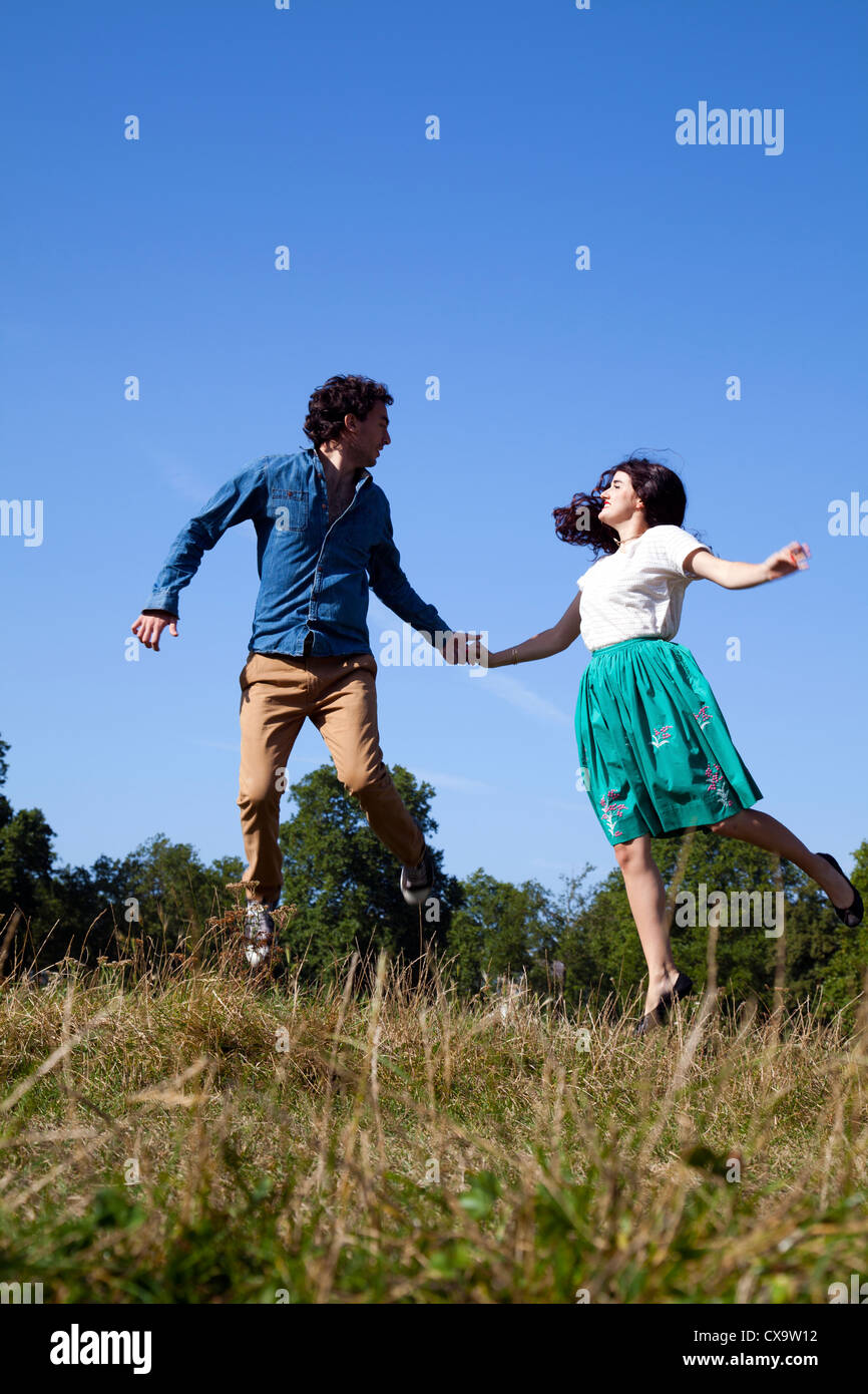 Romantic Couple Jumping in Park Stock Photo - Alamy