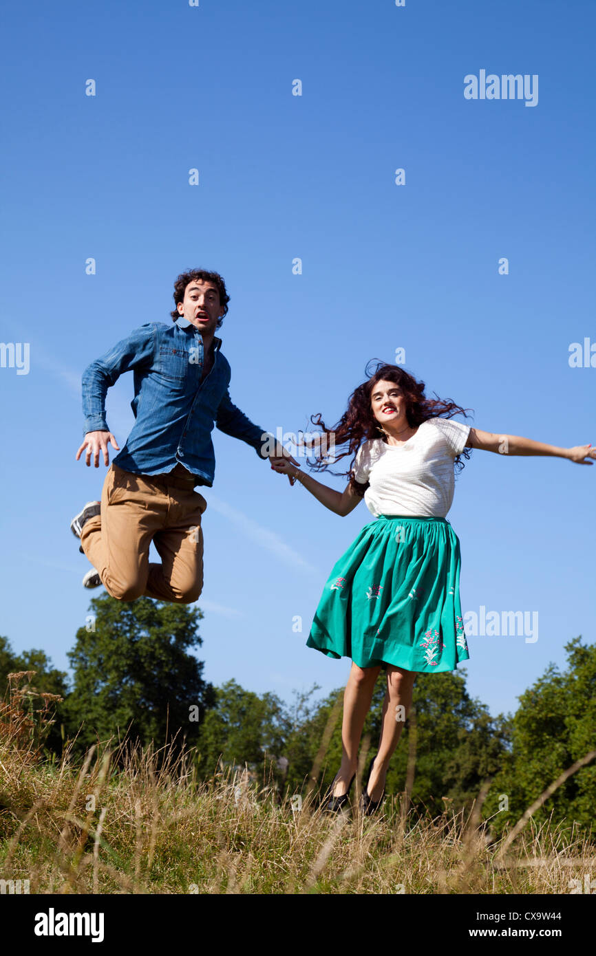 Romantic Couple Jumping in Park Stock Photo - Alamy